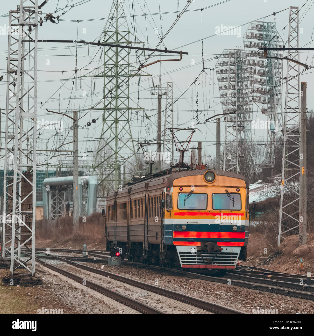 Old yellow passenger electric train driving at the terminal Stock Photo ...
