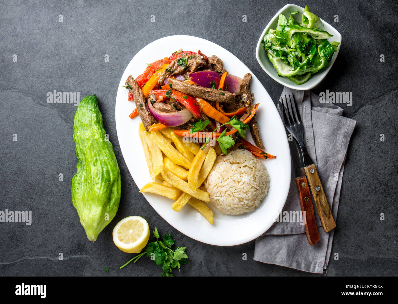 Peruvian dish Lomo saltado - beef tenderloin with purple onion, yellow ...