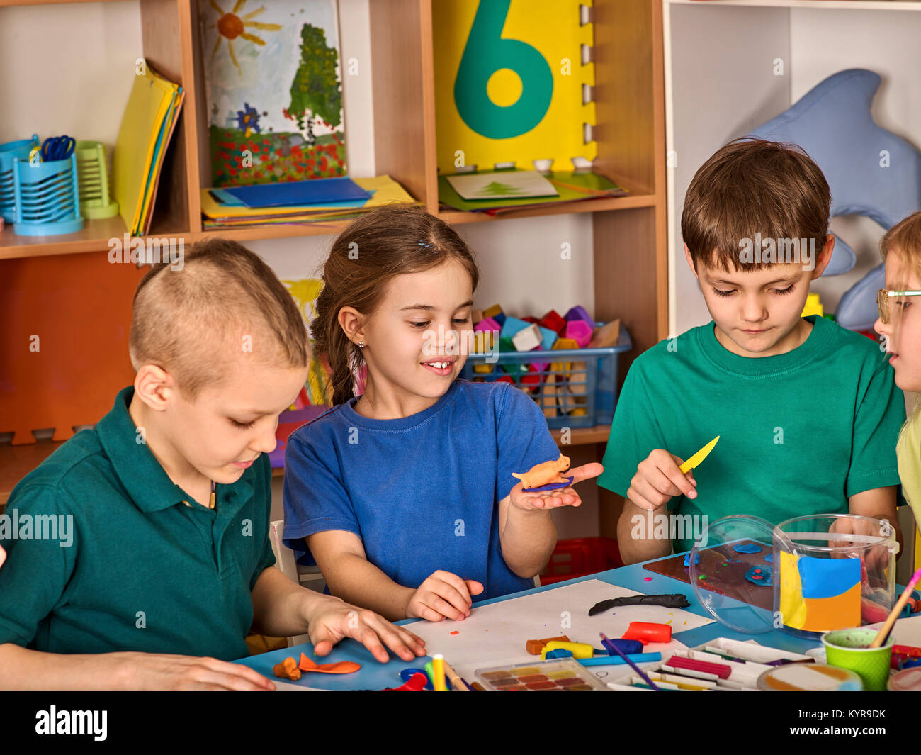 Plasticine modeling clay in children class. Teacher teaches in school ...