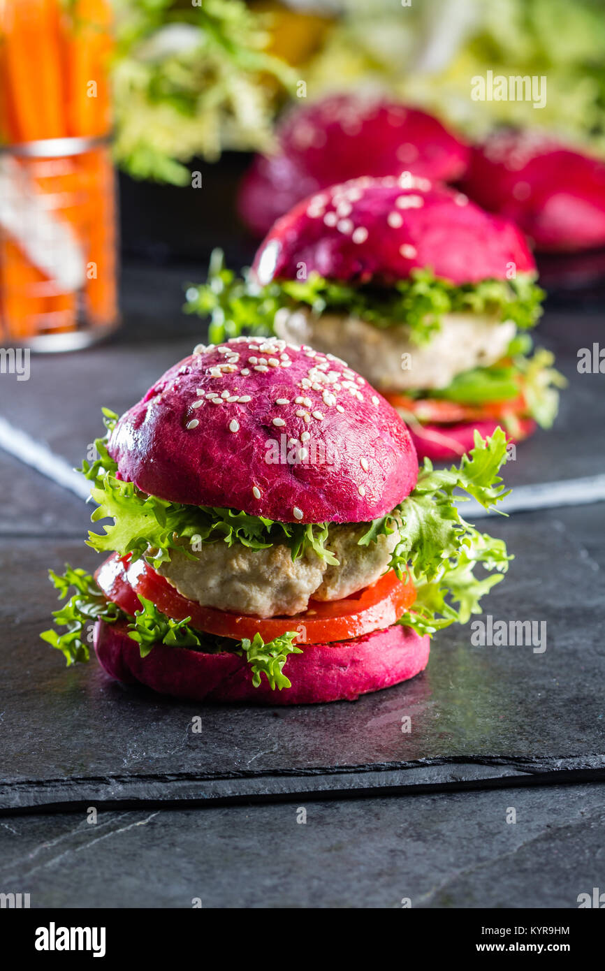 Colored purple beetroot burgers. Chicken burgers hamburgers with ...
