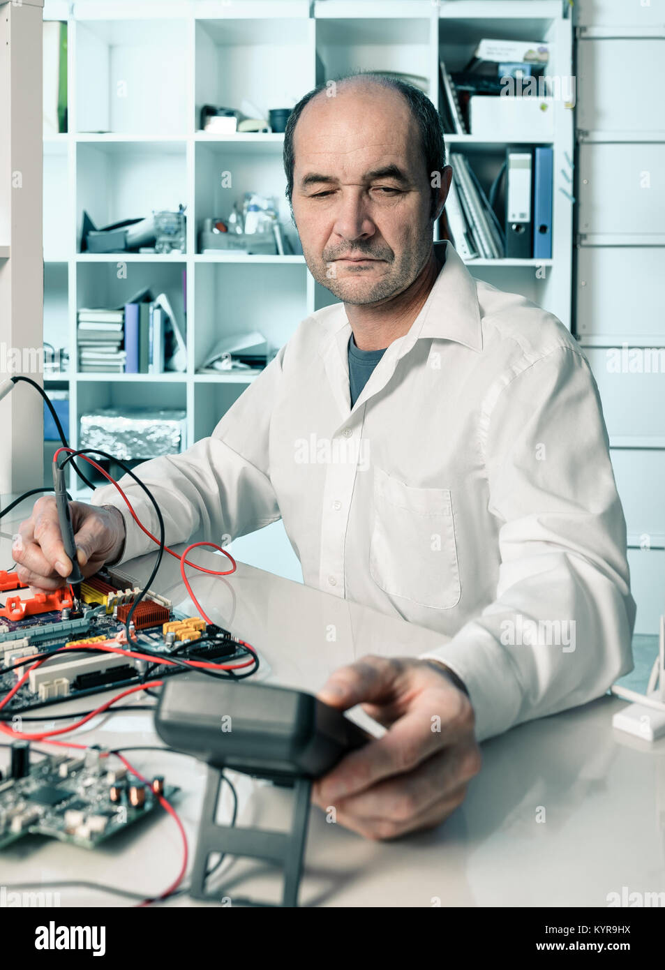 Senior male tech tests electronic equipment Stock Photo - Alamy