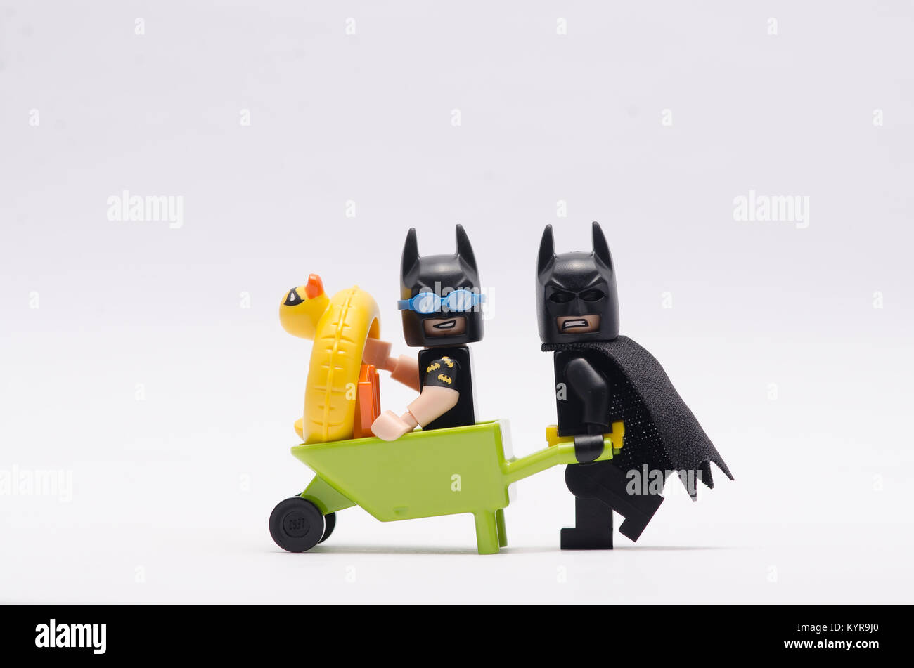 lego batman pushing wheelbarrow with vacation batman sitting on it ...