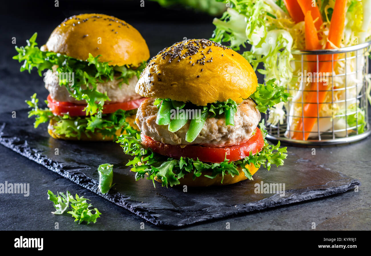Colored yellow burgers. Homemade American chicken burgers hamburgers ...