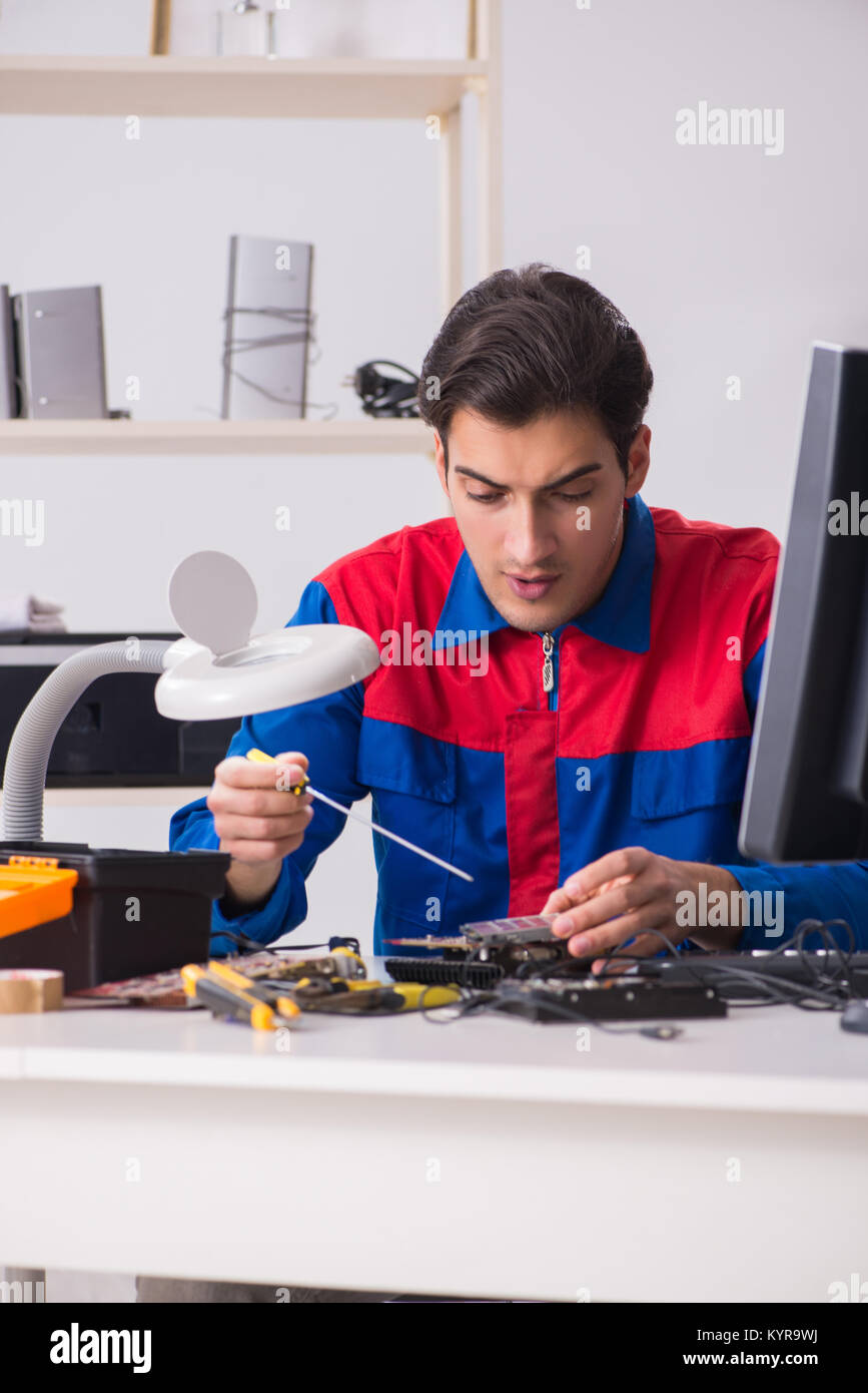Professional repairman repairing computer in workshop Stock Photo - Alamy