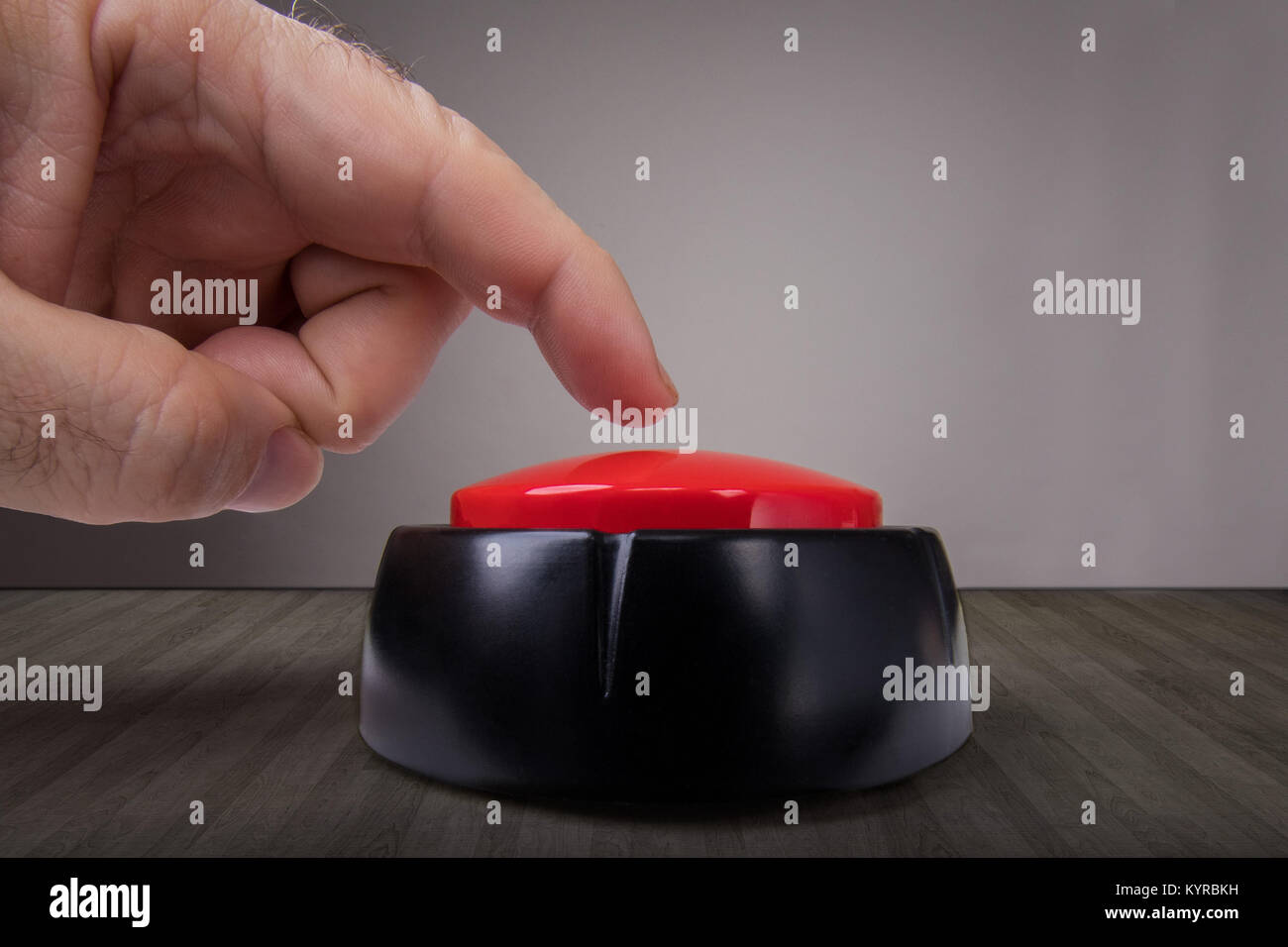 Finger poised over a big red button Stock Photo - Alamy