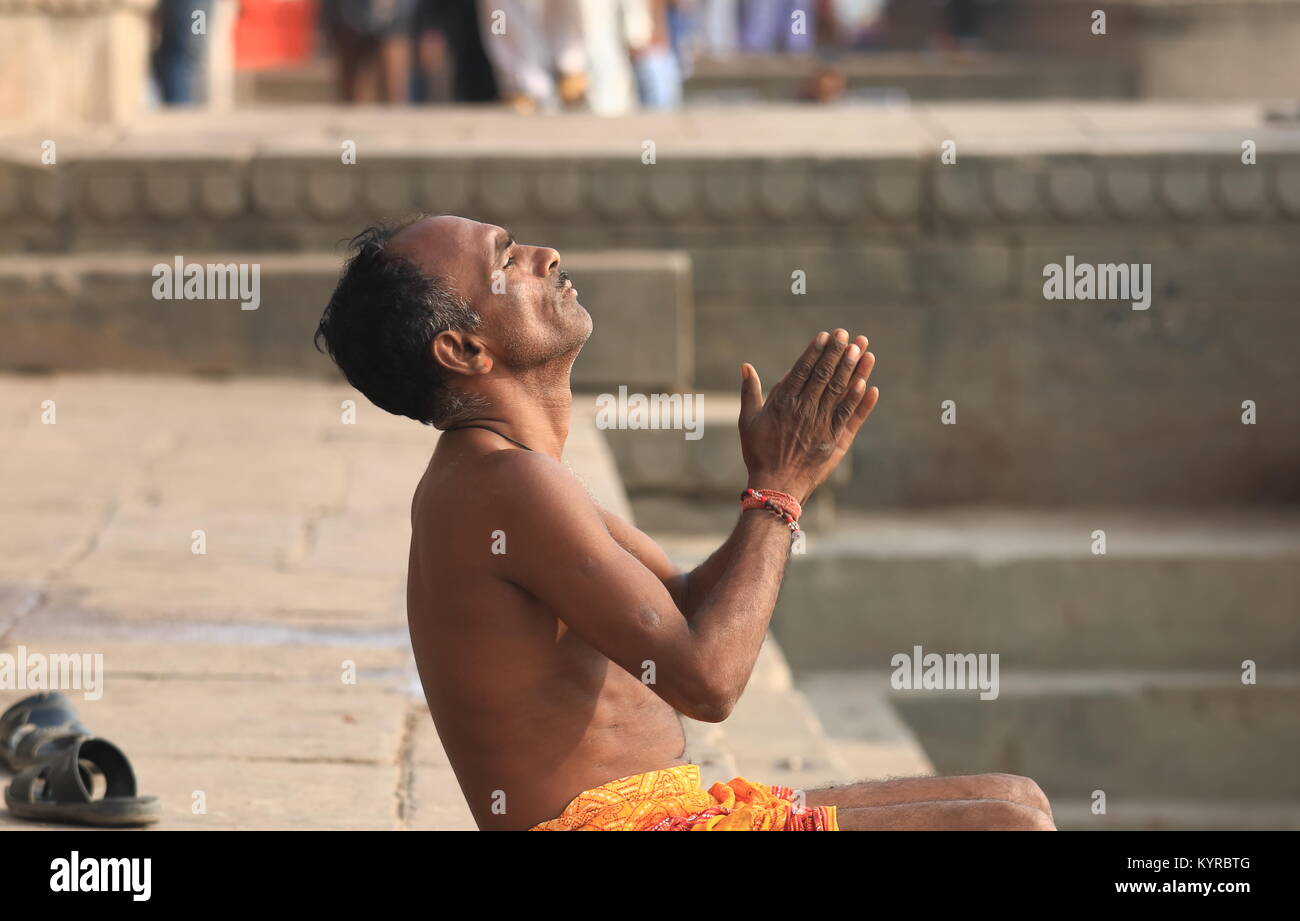 Indian man prays in Ganges river ghat in Varanasi India Stock Photo - Alamy