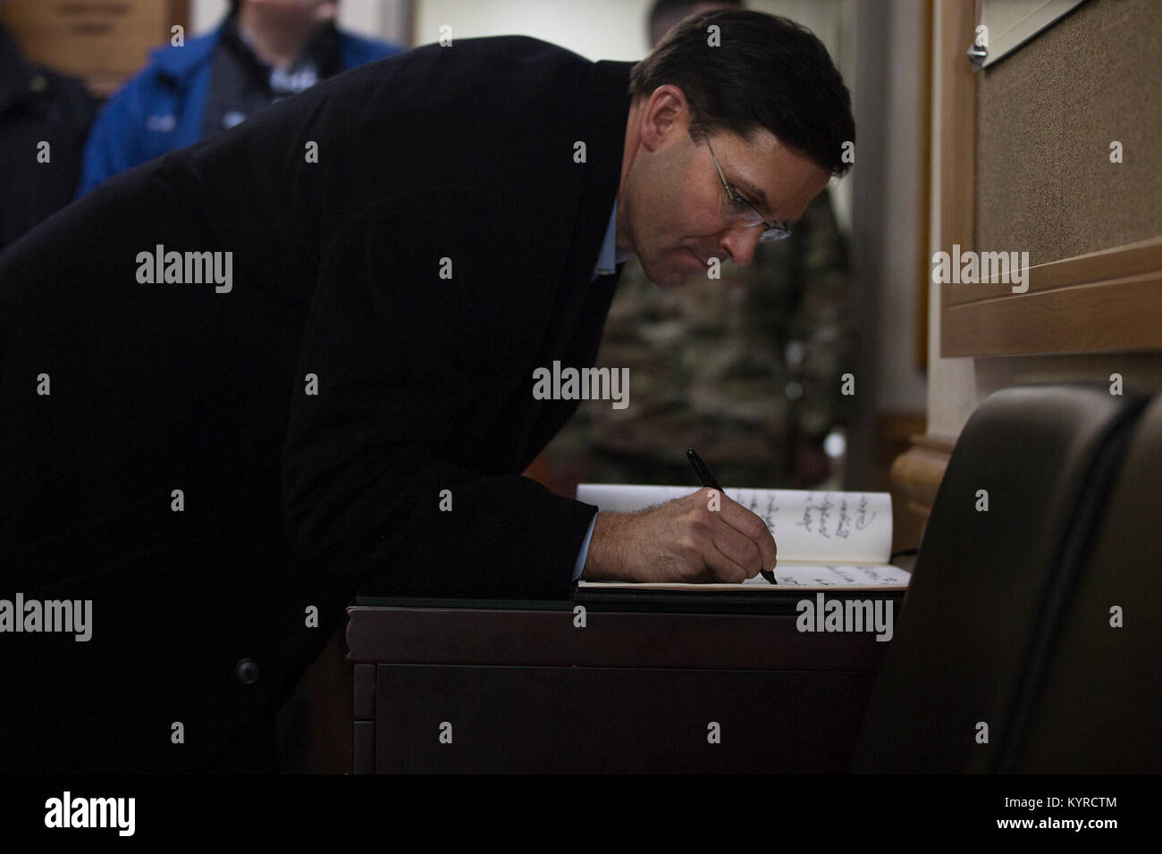 Secretary of the Army Mark T. Esper signs a welcome book before meeting ...