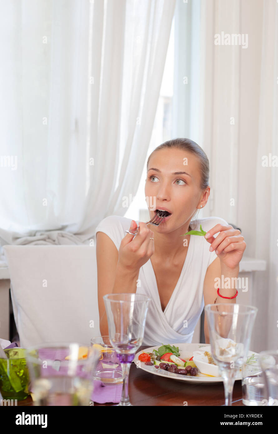 A young beautiful woman is eating in a restaurant Stock Photo - Alamy