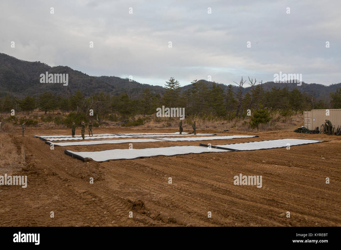 U.S. Marines with Marine Wing Support Squadron (MWSS) 171 sweep dirt ...