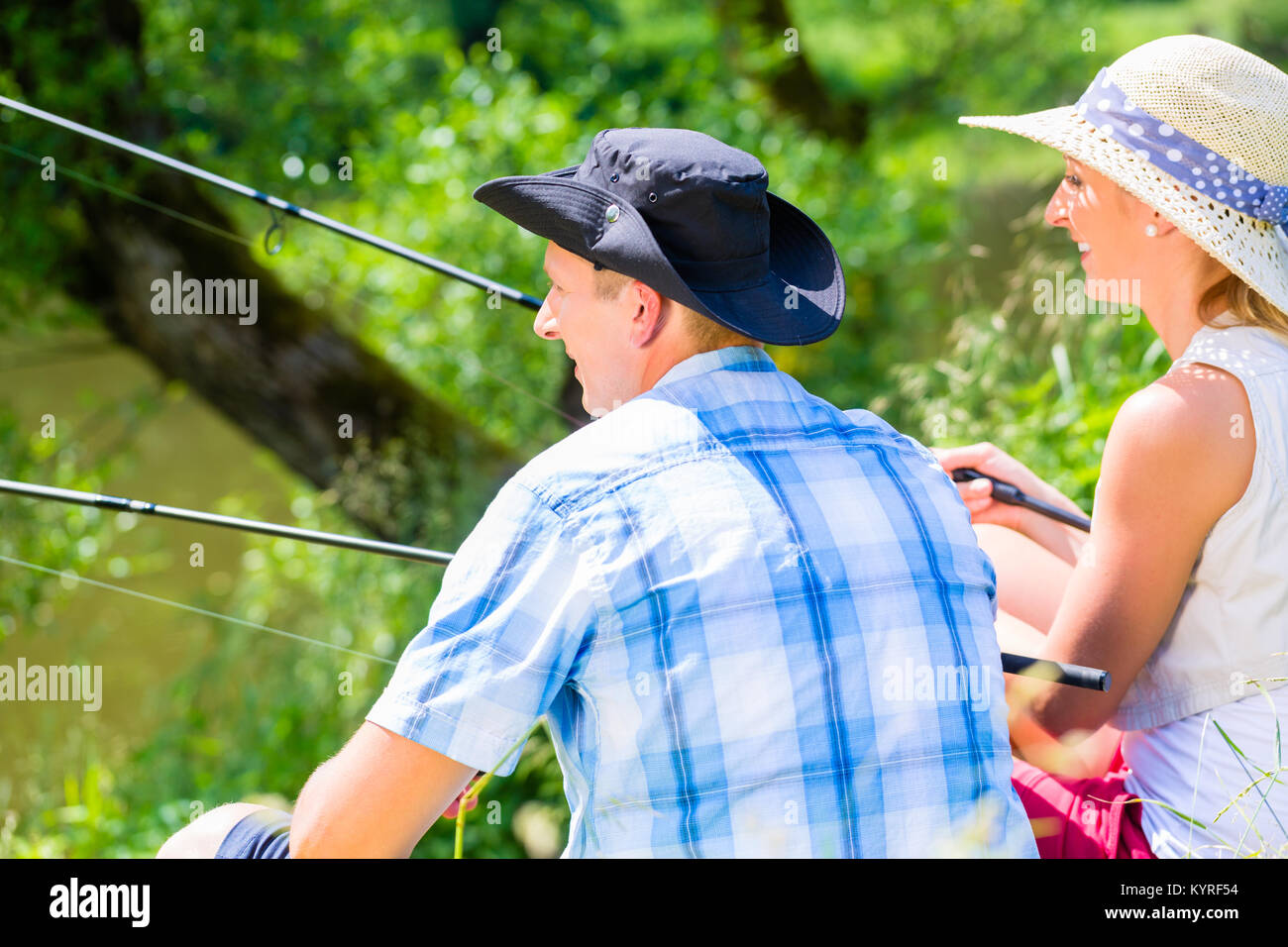 Couple, woman and man, with fishing rods sport angling Stock Photo - Alamy