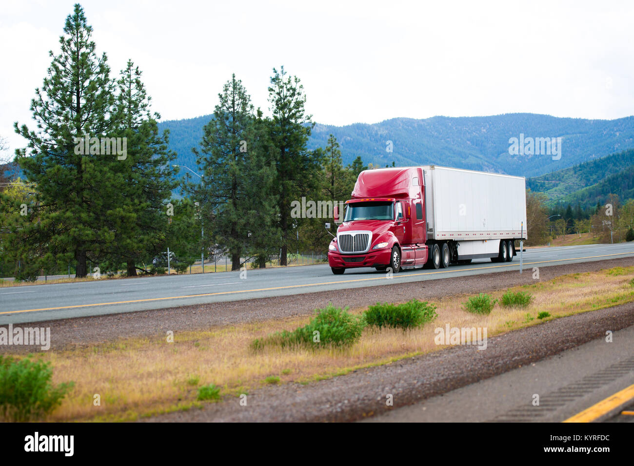 Red big rig modern shiny semi-truck with white dry van trailer with ...