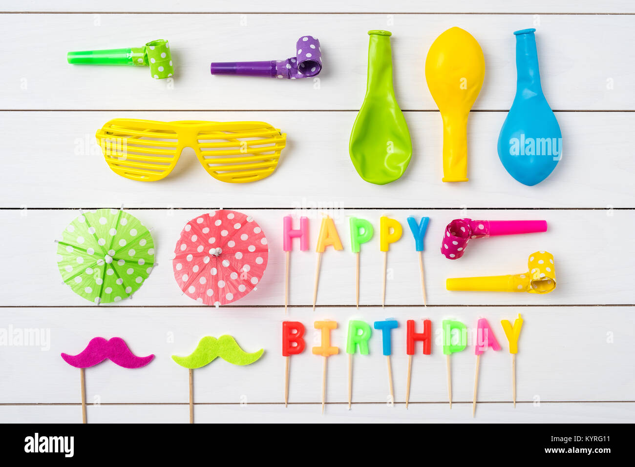 Birthday accessories on white wooden table. Top view Stock Photo - Alamy