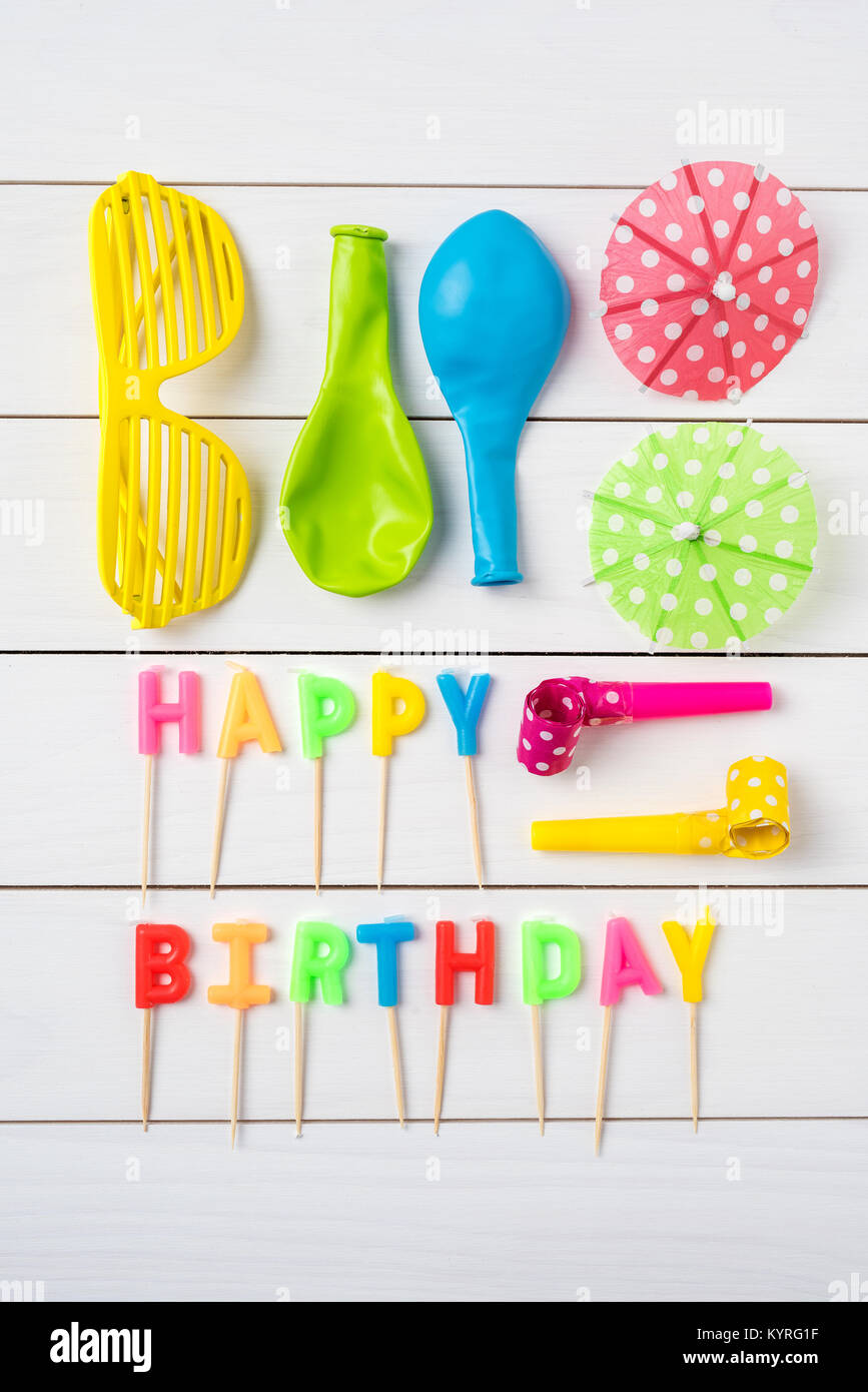 Birthday accessories on white wooden table. Top view Stock Photo - Alamy