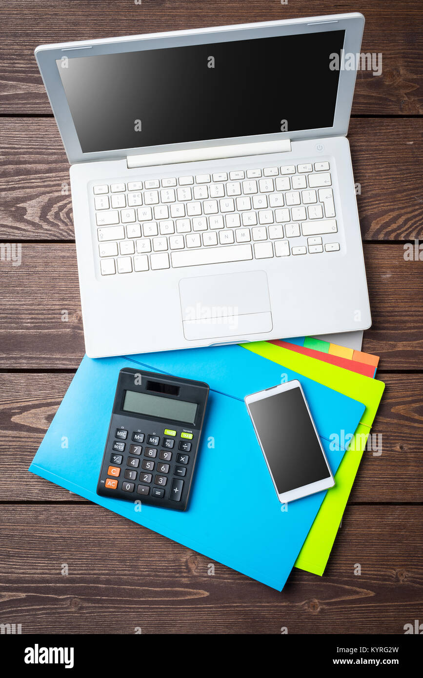 White computer with documents and accessories on wooden table Stock ...