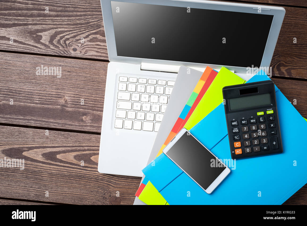 White computer with documents and accessories on wooden table Stock ...