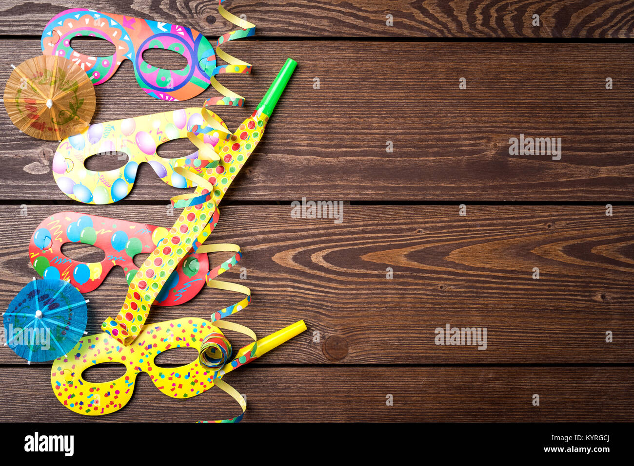 Colorful party background on wooden table Stock Photo - Alamy