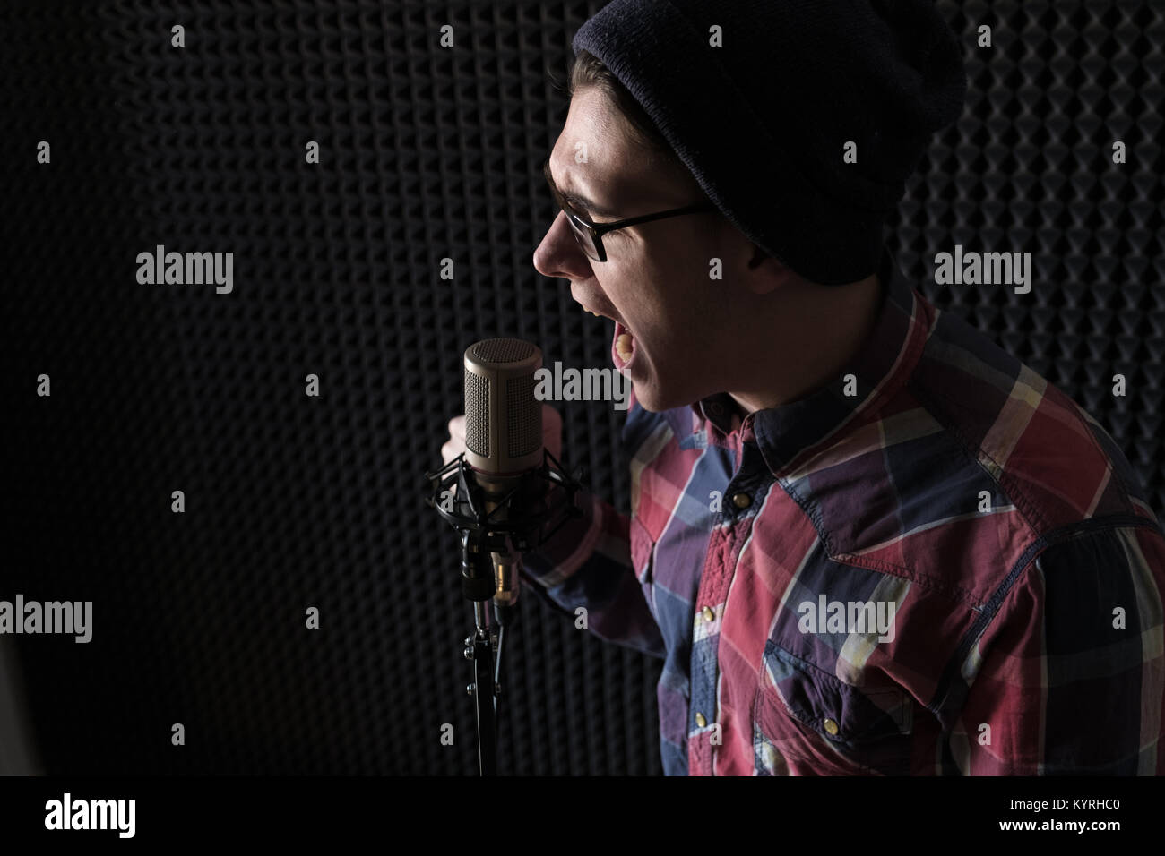 Singer is singing in glasses microphone hi-res stock photography and ...