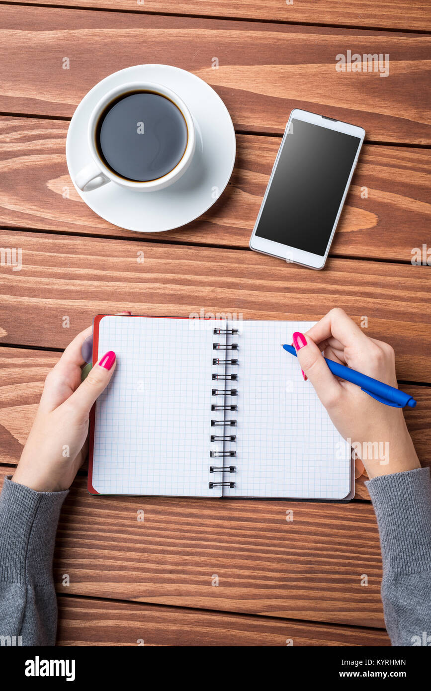 Overhead shot of woman writing in empty notebook Stock Photo - Alamy