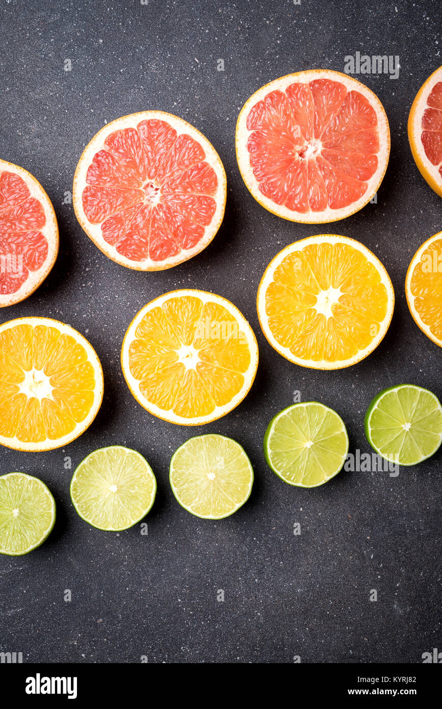 Half of citrus fruits on dark stone background Stock Photo - Alamy