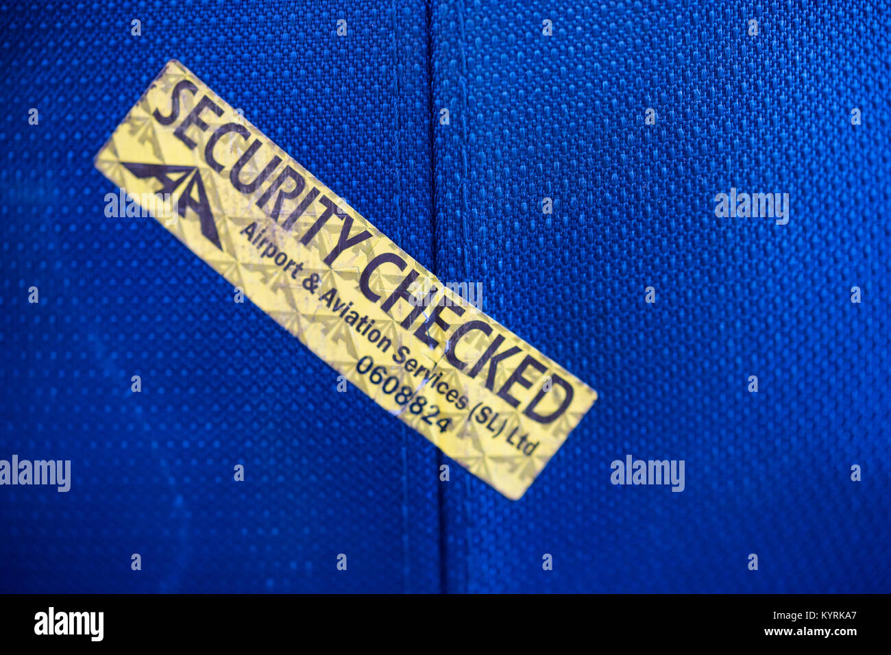 Close up security checked label on blue suitcase Stock Photo - Alamy