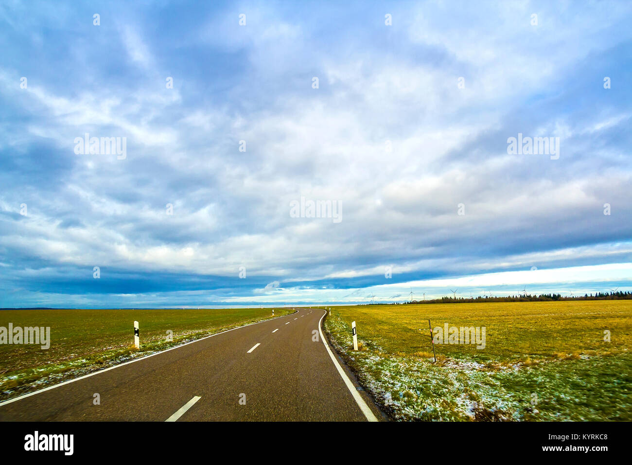 Empty black asphalt road between green fields Stock Photo - Alamy