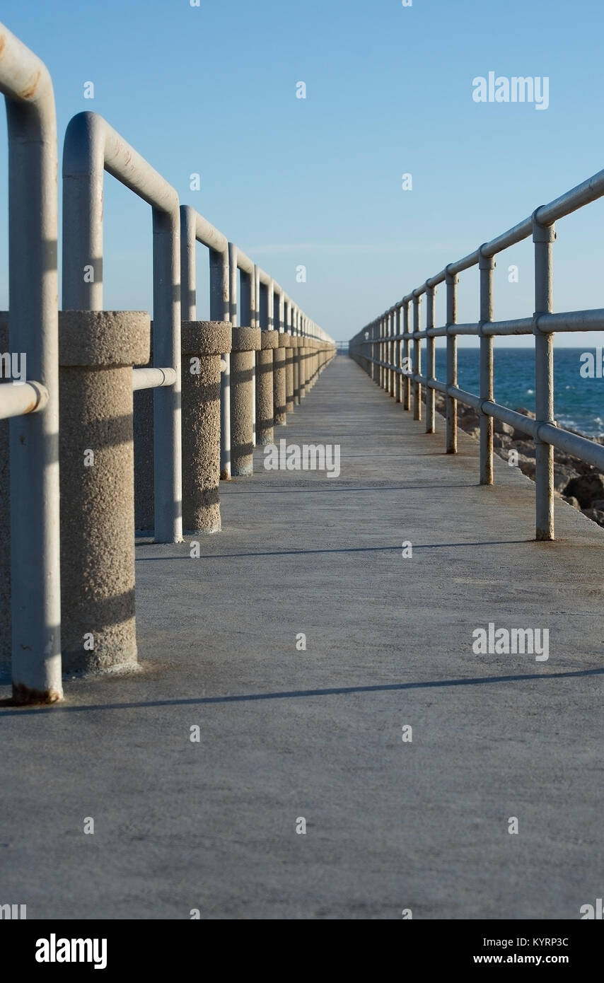 Pier structure with perspective towards the ocean horizon Stock Photo ...