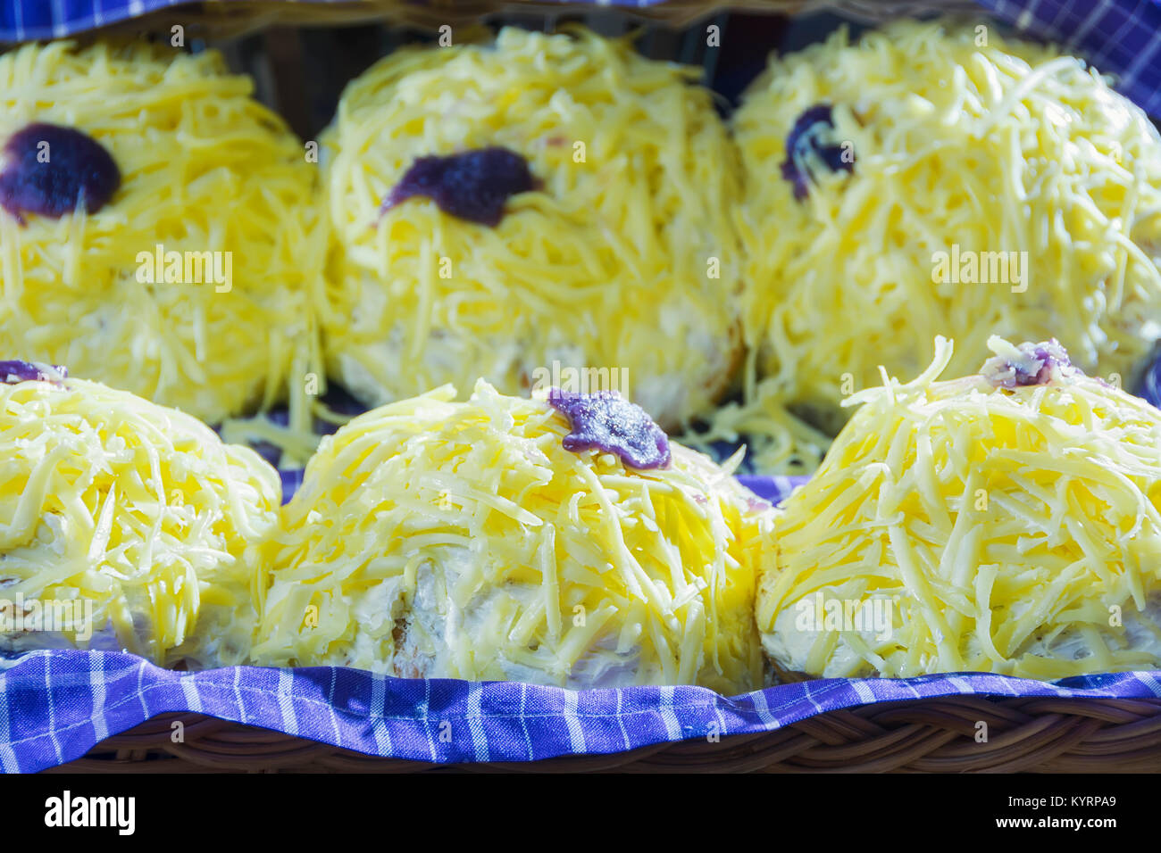 Ensaymada bursting with shredded cheese and topped with sweet yam Stock ...