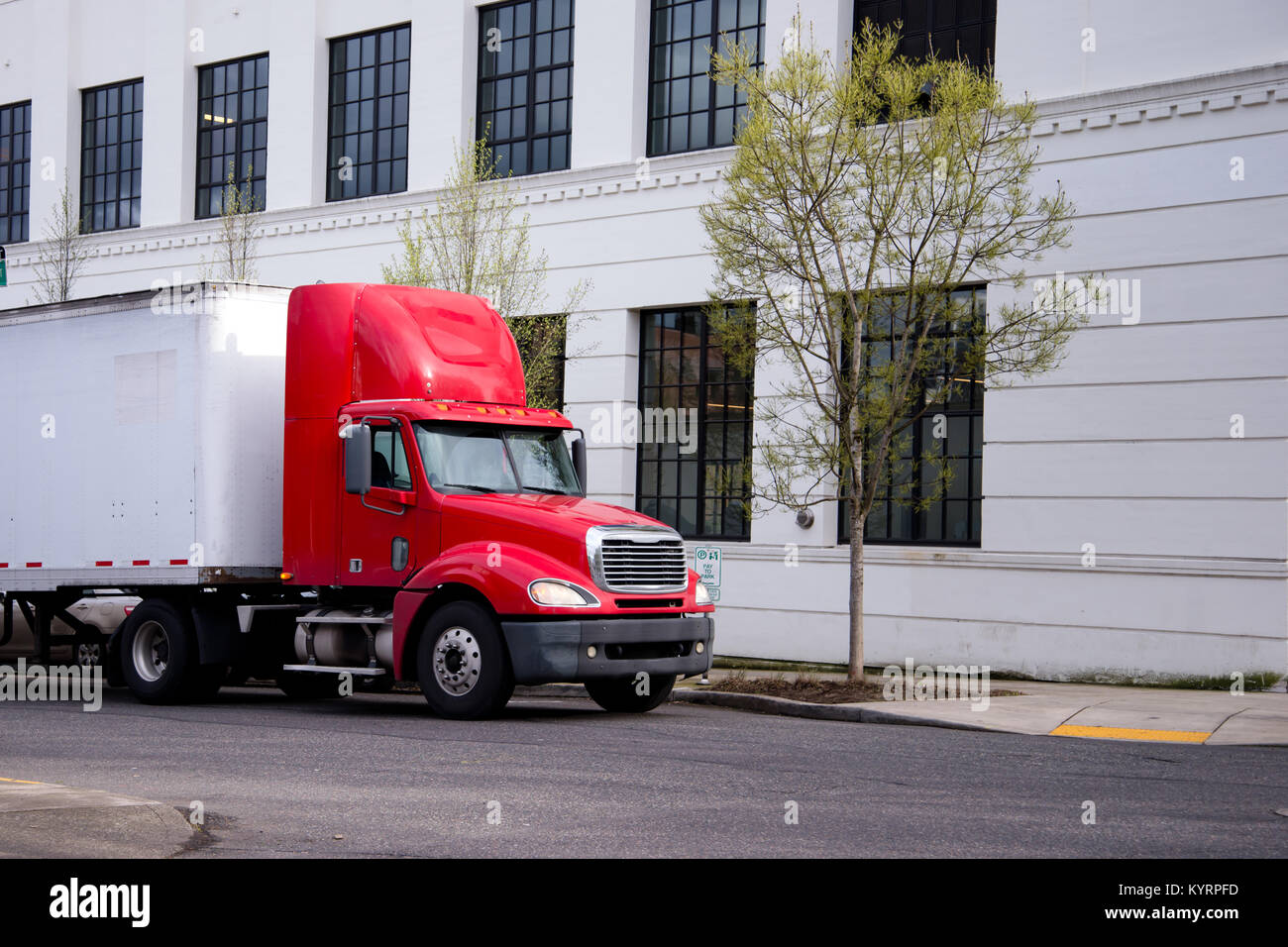Red semi truck with short day cab and high spoiler to improve ...
