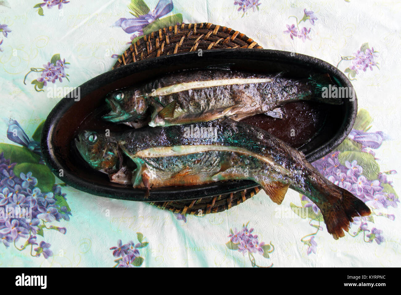Fish on the plate on the table in restaurant Stock Photo - Alamy