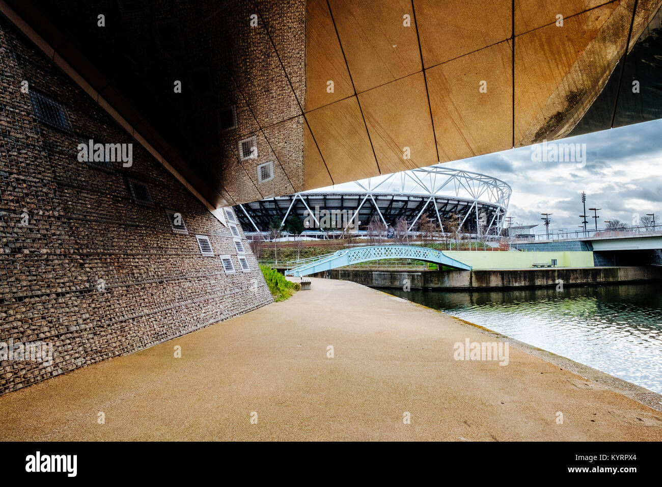 A reflective bridge with the London Olympic Stadium visible in the ...