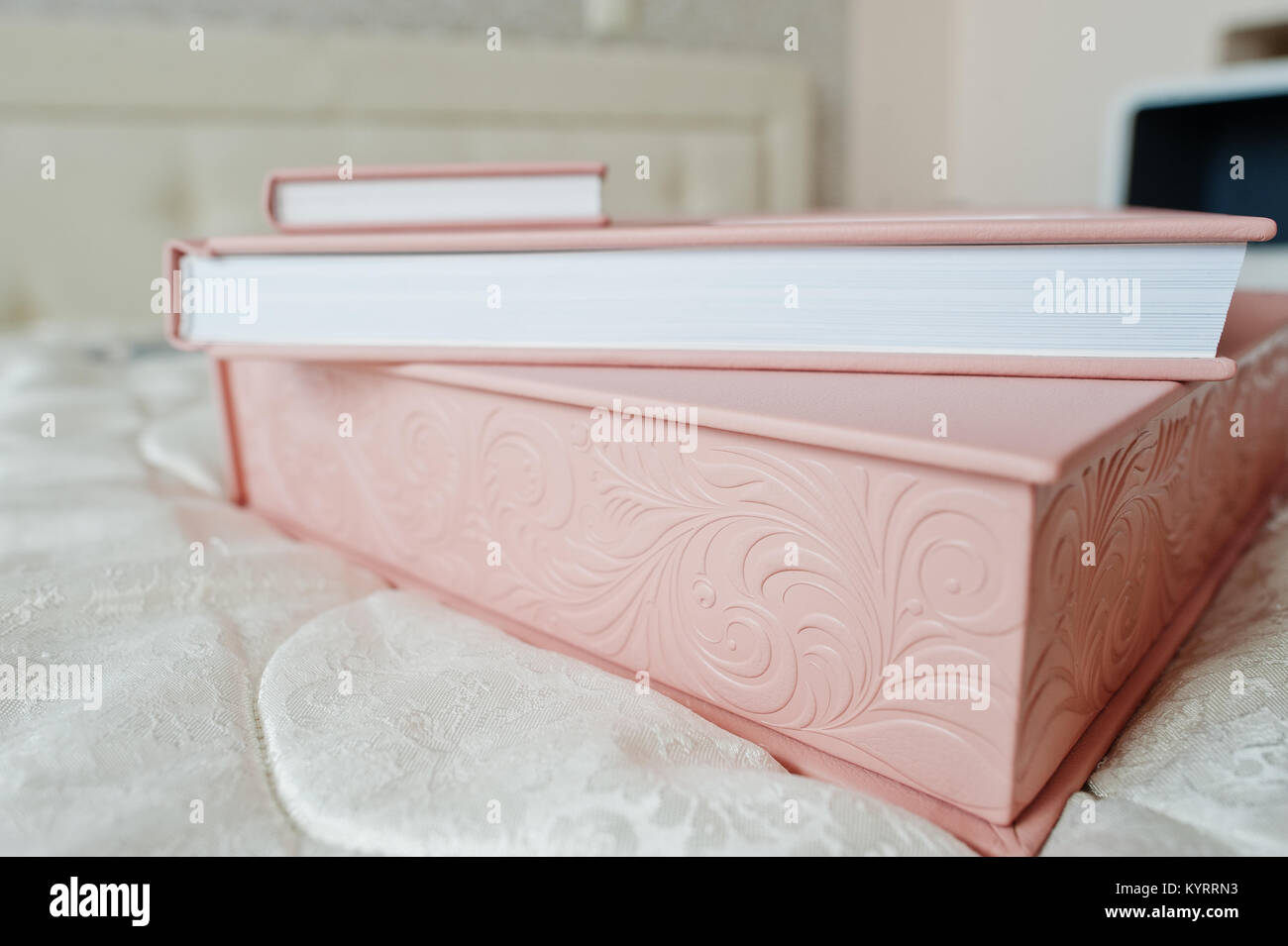 Gentle pink wedding photobook or photo album, box, and cd case laying ...