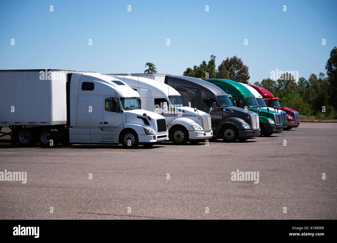 Colorful modern big rigs Semi-trucks and trailers of different makes ...