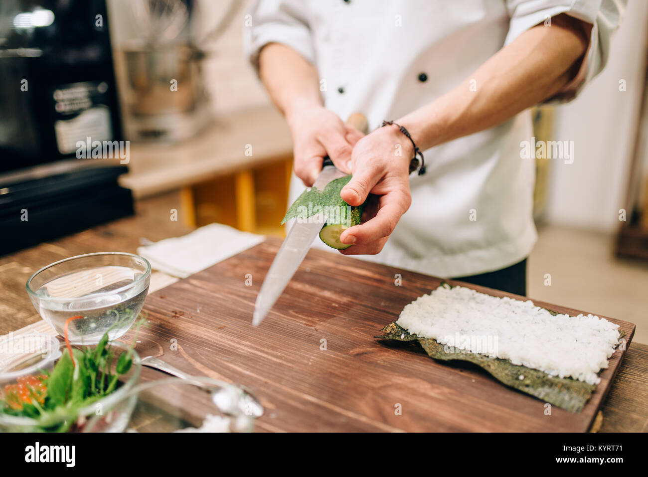 Sushi preparation process, traditional japanese cuisine. Male cook ...