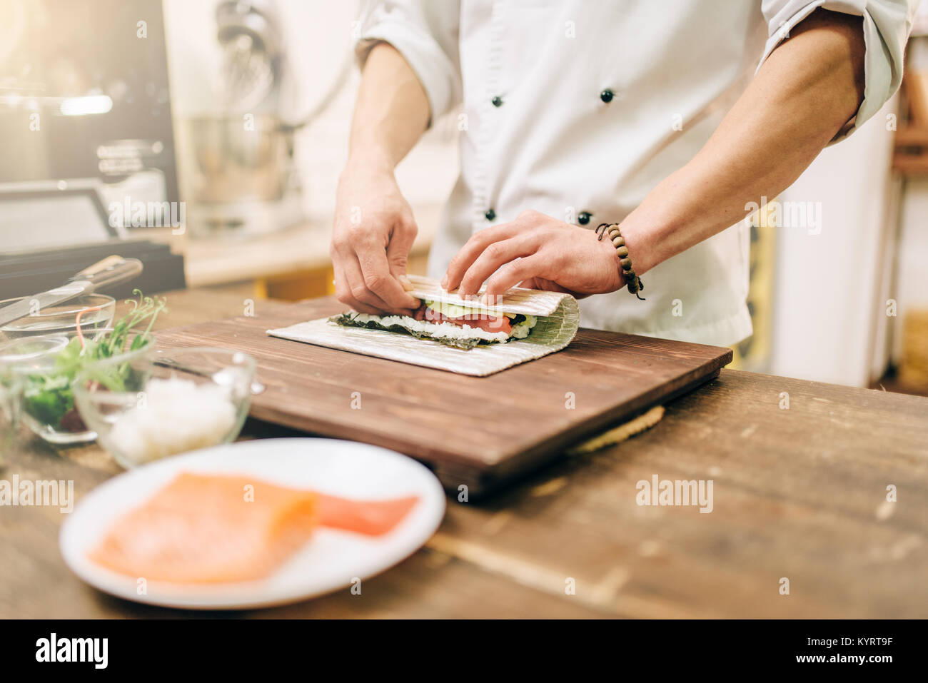 Male cook making seafood on wooden table, asian kitchen preparation ...