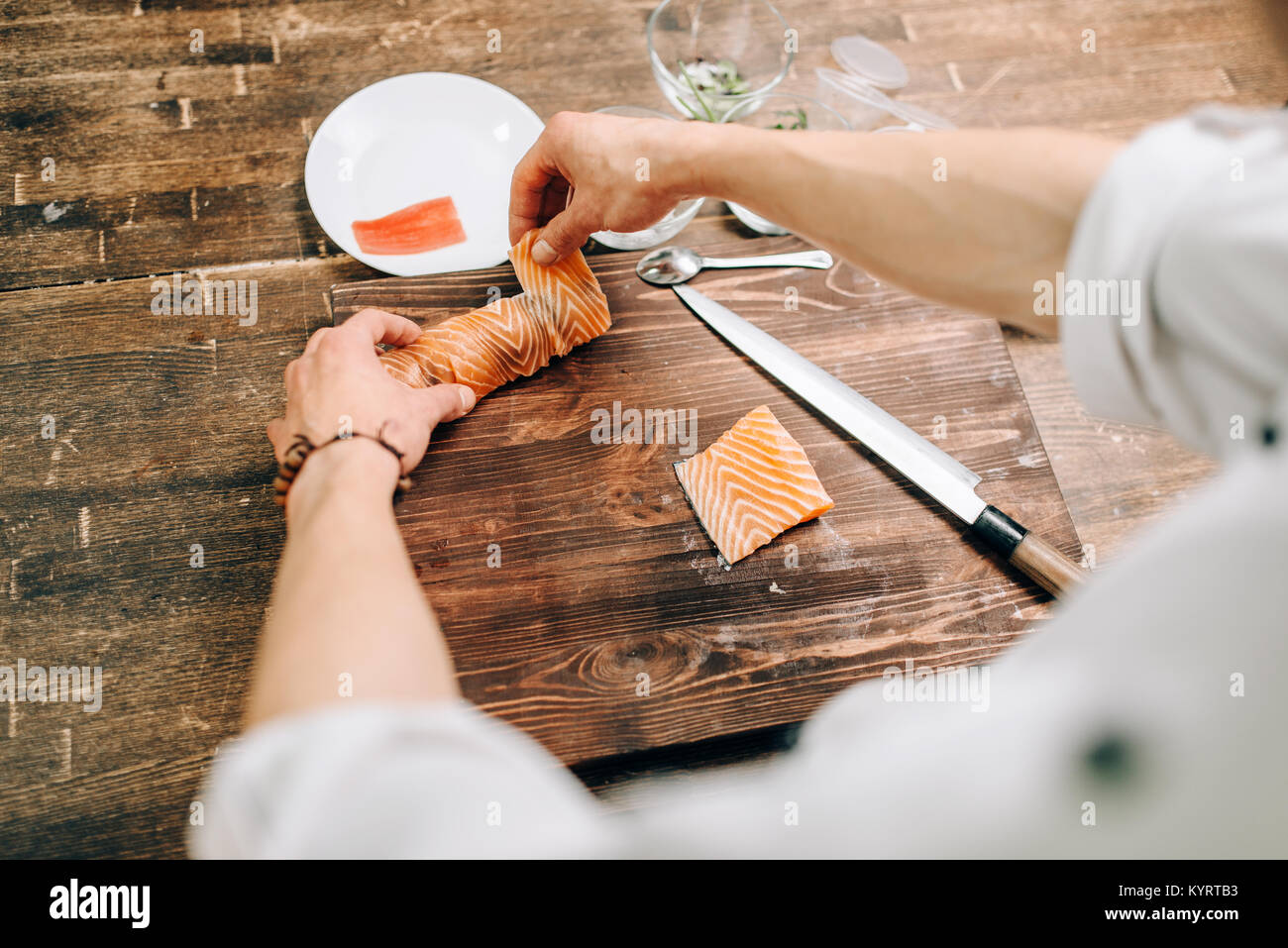 Male person cooking seafood on wooden table, japanese kitchen ...