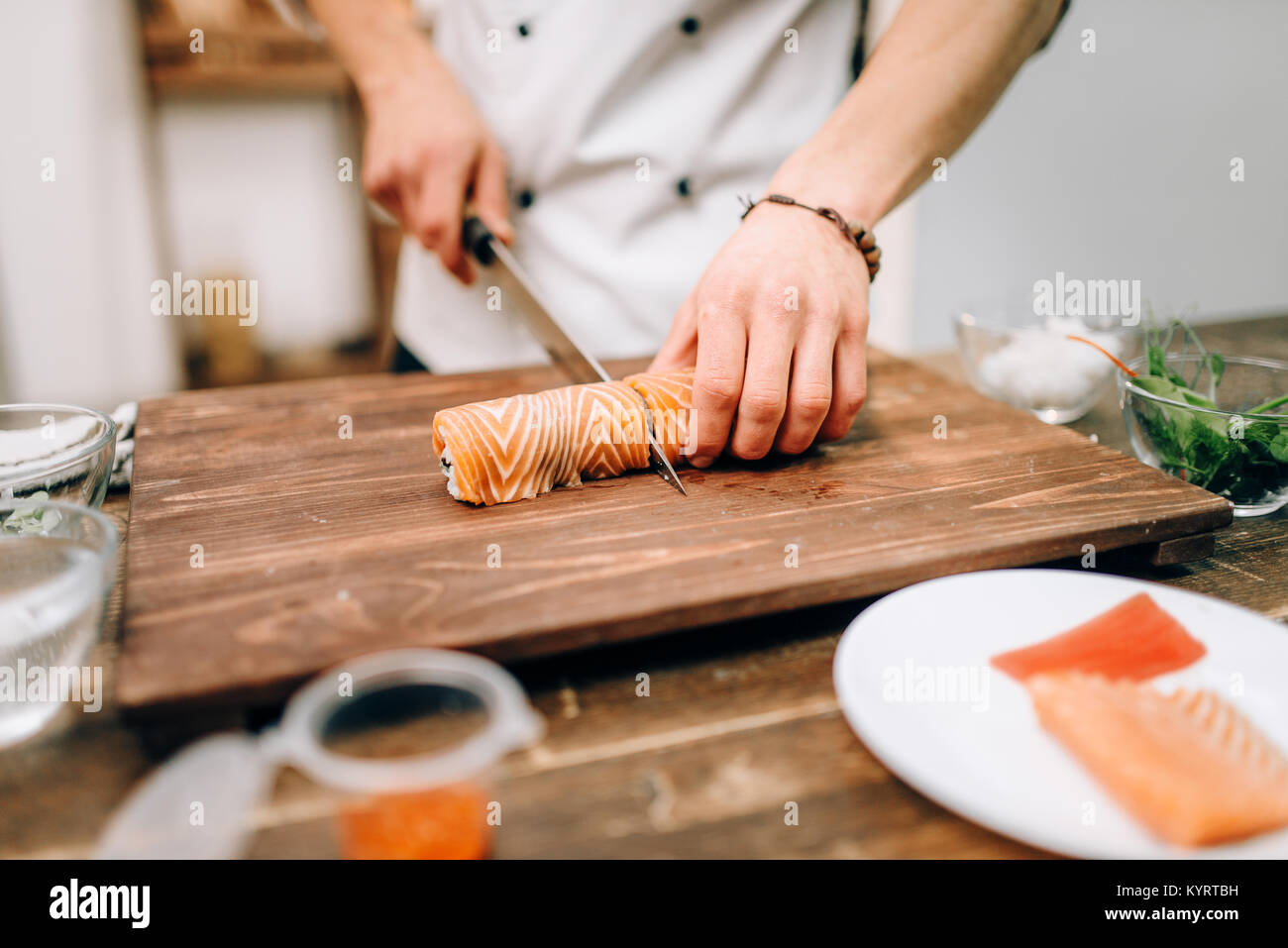 Male person cooking sushi on wooden table, japanese food preparation ...