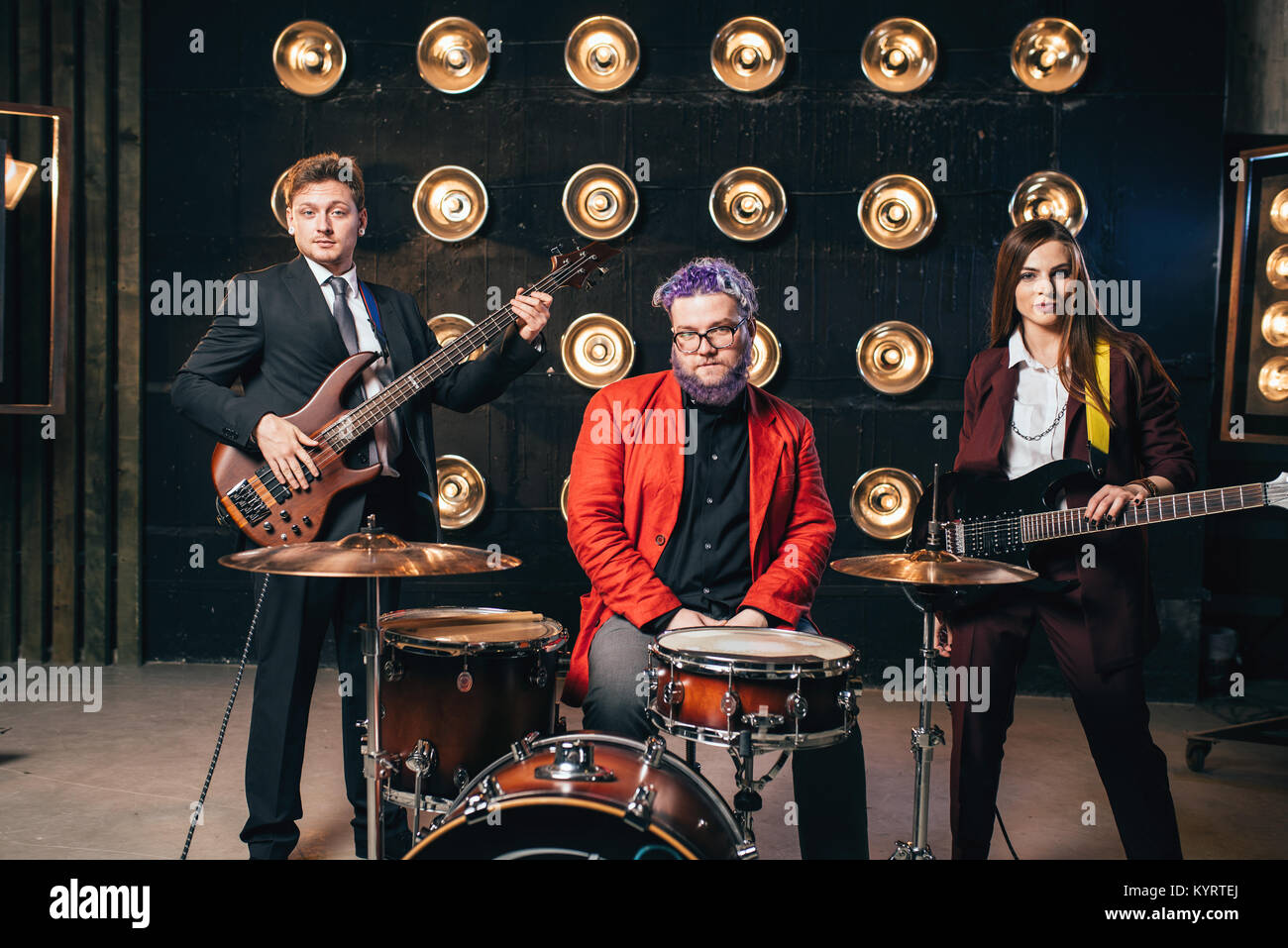 Musical group in suits on the stage with lights, retro style ...