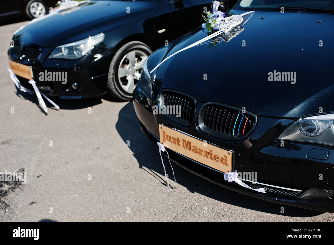 Black wedding BMW cars with creative wedding number plates saying "Just ...