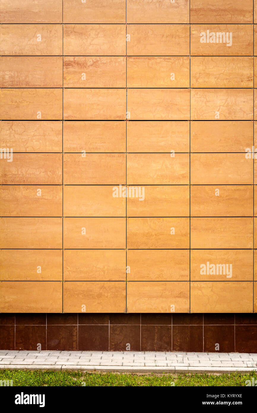 Modern beige metal facade tiles wall and a ground. Abstract ...