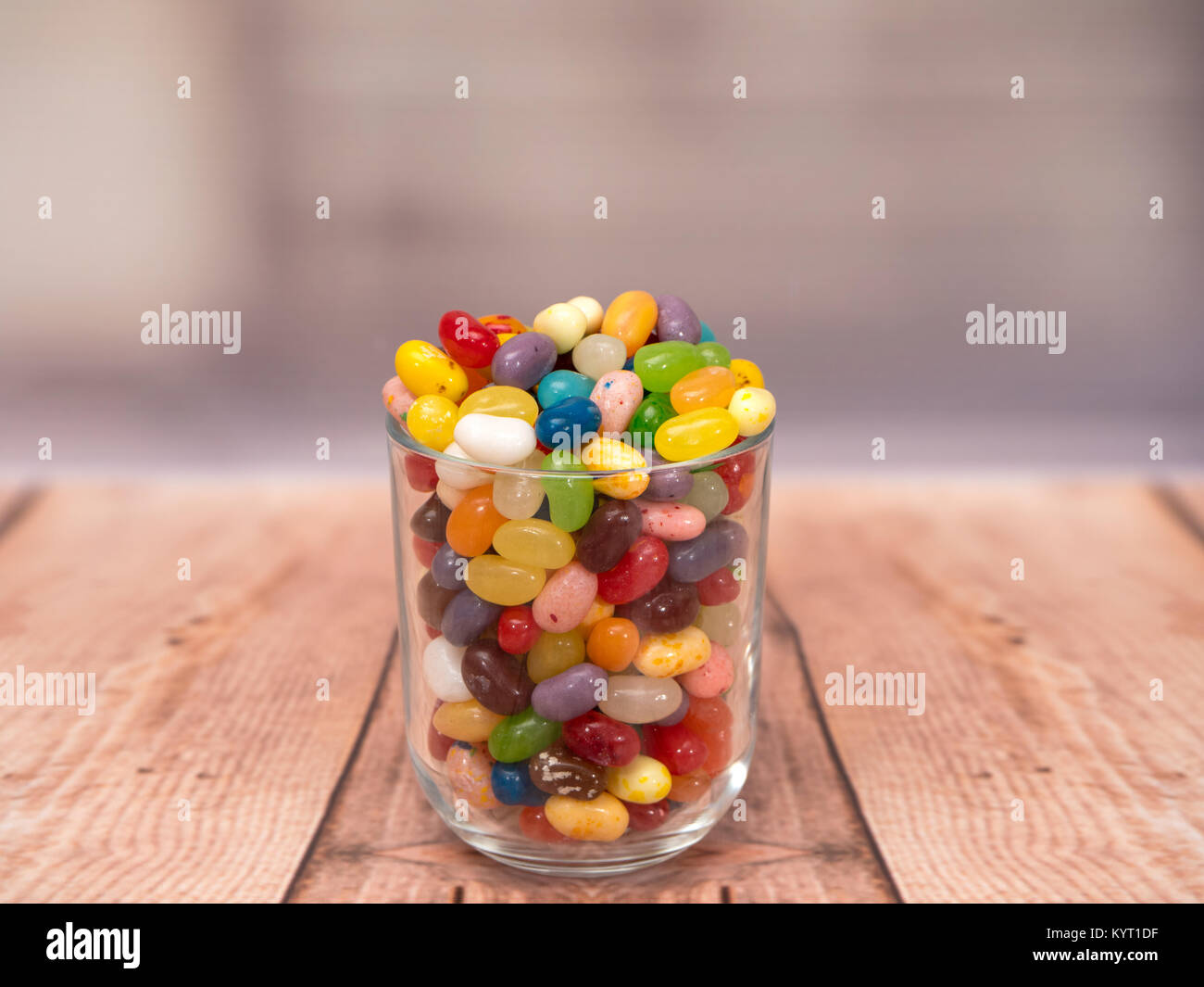 multicoloured jelly beans in a glass on a wooden background Stock Photo ...