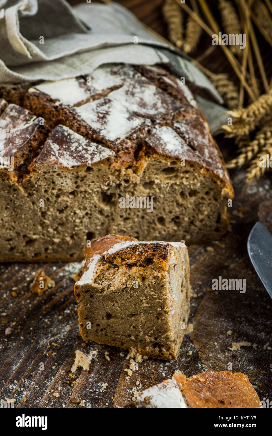 Sharing pieces of freshly baked bread loaf Stock Photo - Alamy