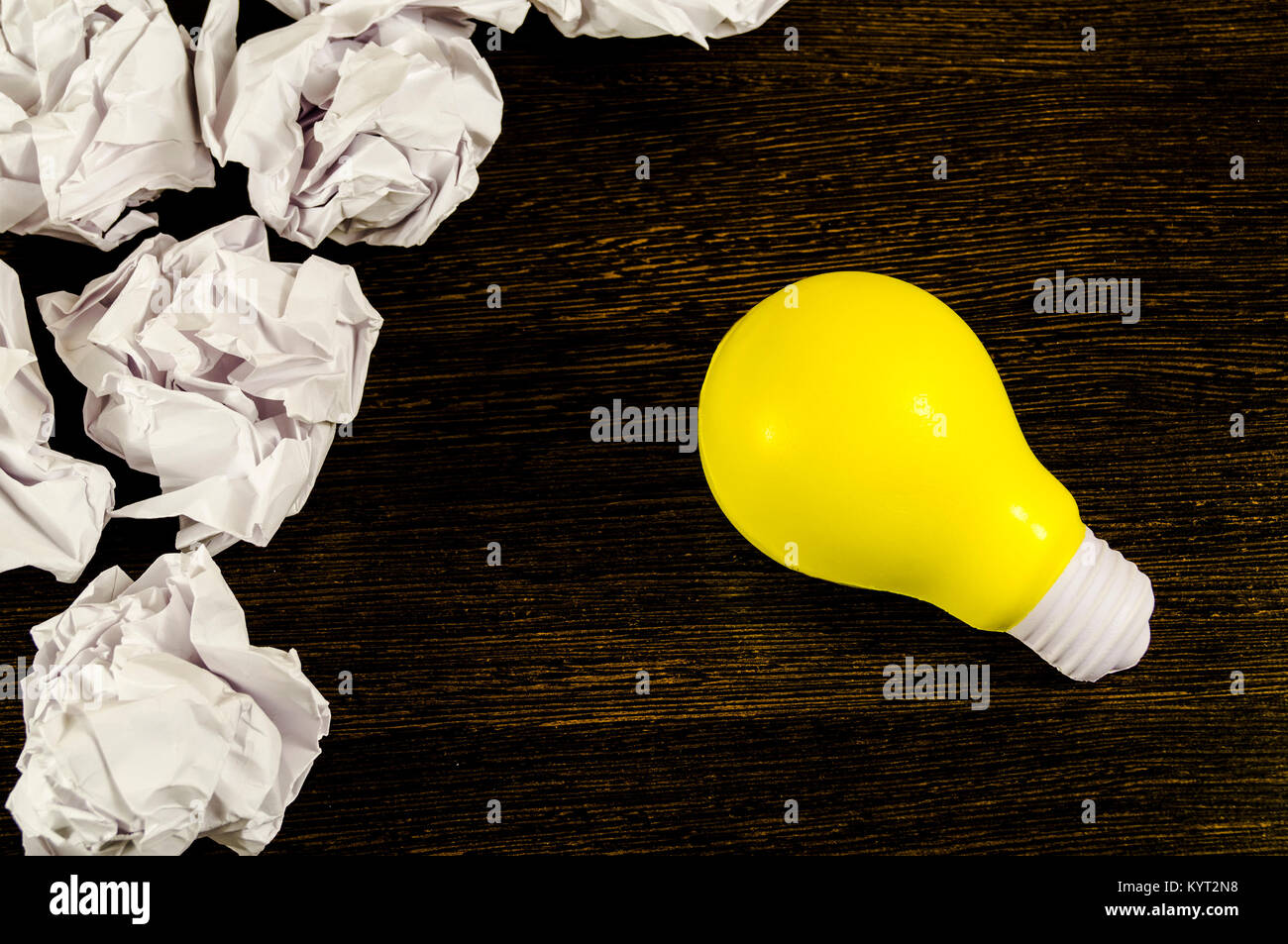 yellow light bulb as a symbol of idea on a dark table Stock Photo - Alamy