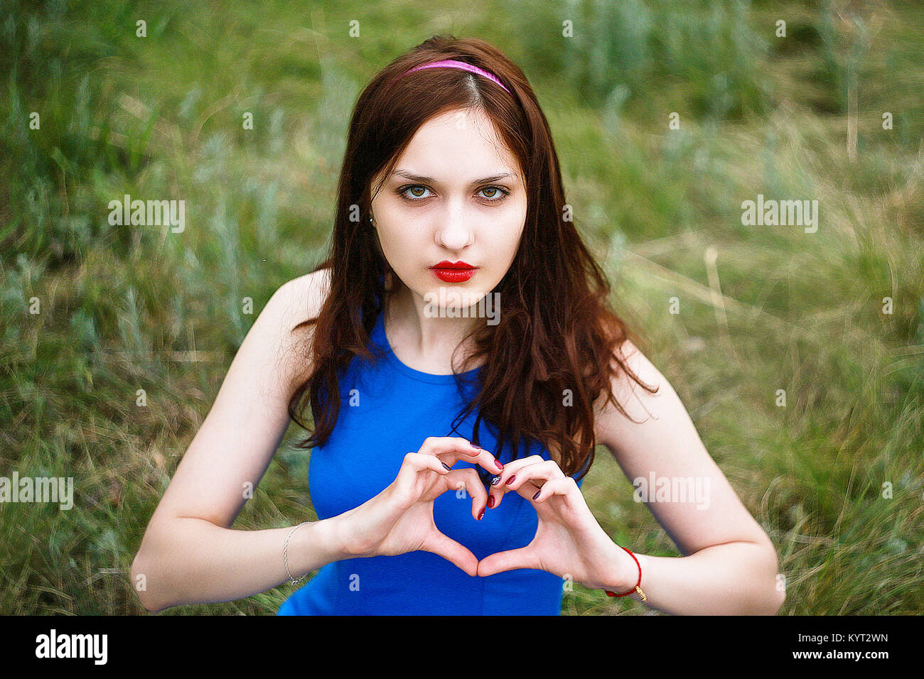 Beautiful girl shows hands the symbol of the heart Stock Photo - Alamy
