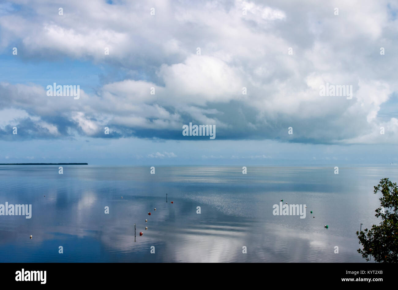 A sea like glass - The perfectly calm ocean mirrors the clouds in the ...