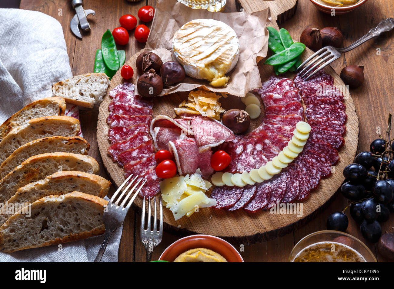 Different delicious meat and cheese snacks on wooden board Stock Photo ...
