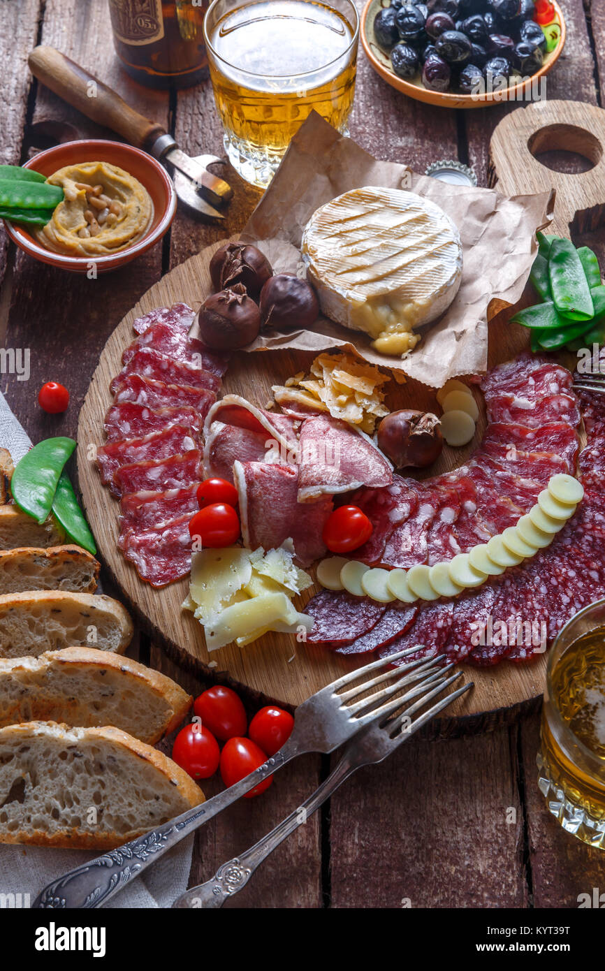 Different delicious meat and cheese snacks on wooden board Stock Photo ...