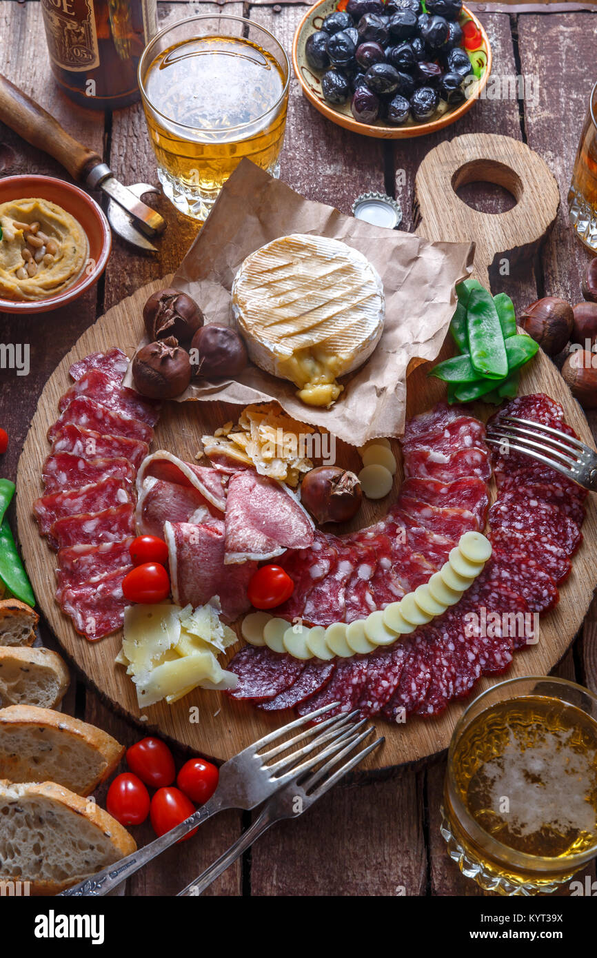 Different delicious meat and cheese snacks on wooden board Stock Photo ...