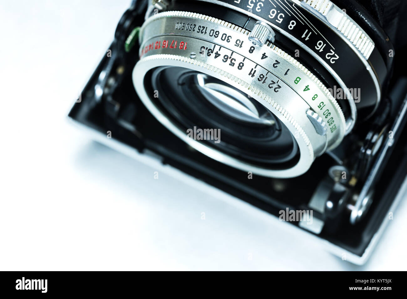 detailed view of old retro camera lens and dials on white background ...