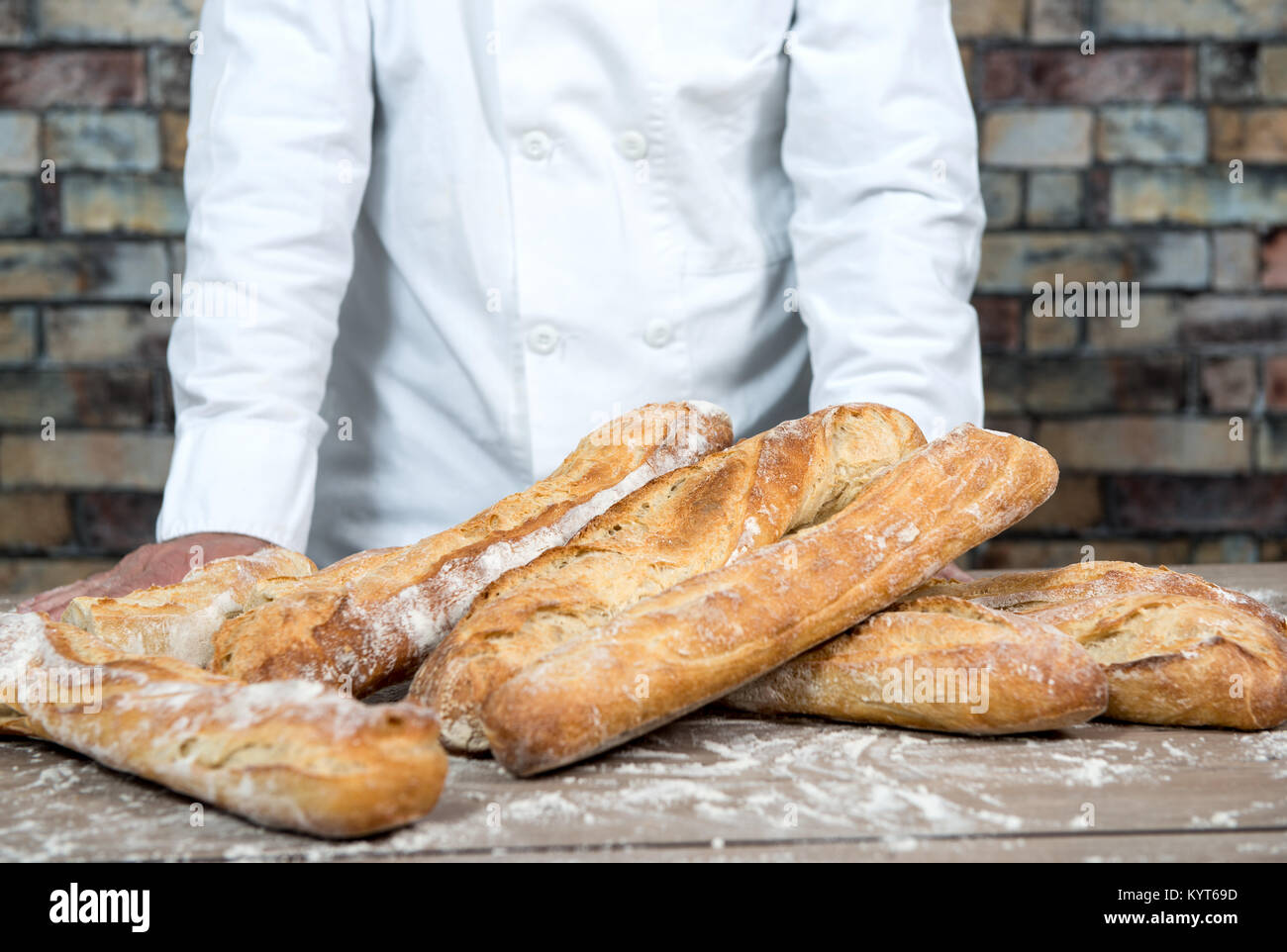 baker with traditional bread french baguettes Stock Photo - Alamy