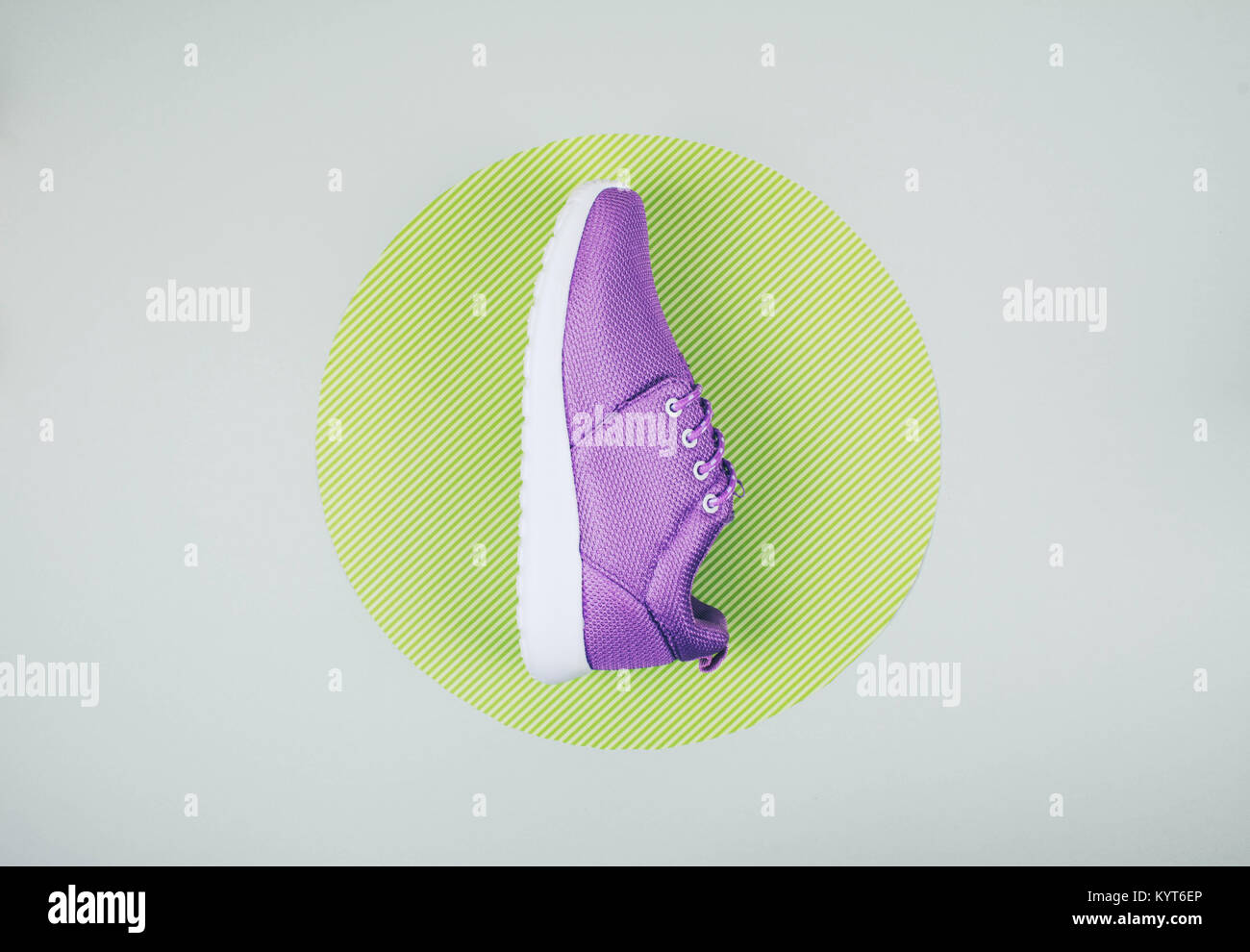 Lilac sneakers on a multi colored pastel surface Stock Photo - Alamy